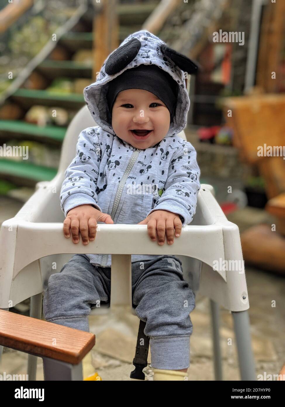 Happy boy sitting in a chair laughing Stock Photo - Alamy