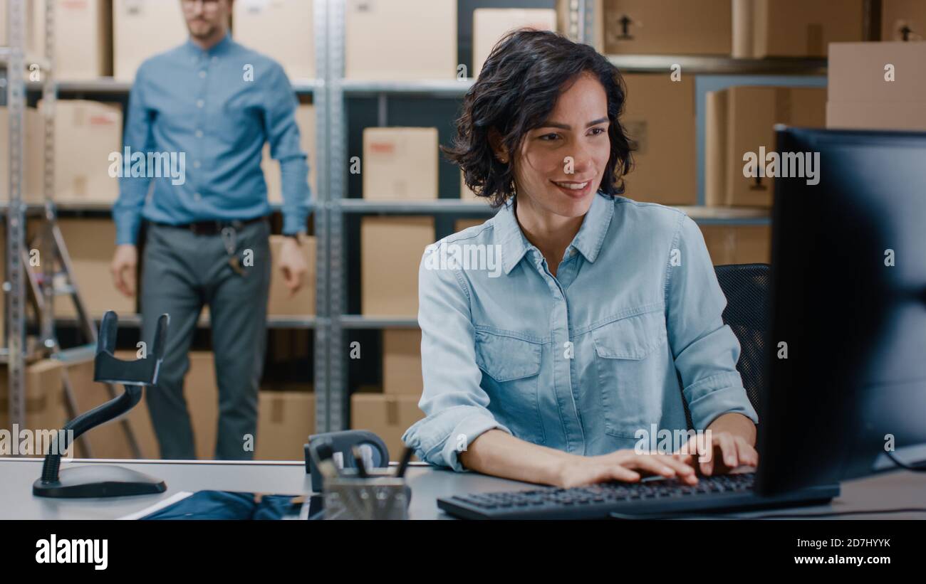 Female Inventory Manager Sitting at Her Desk and Using Personal ...