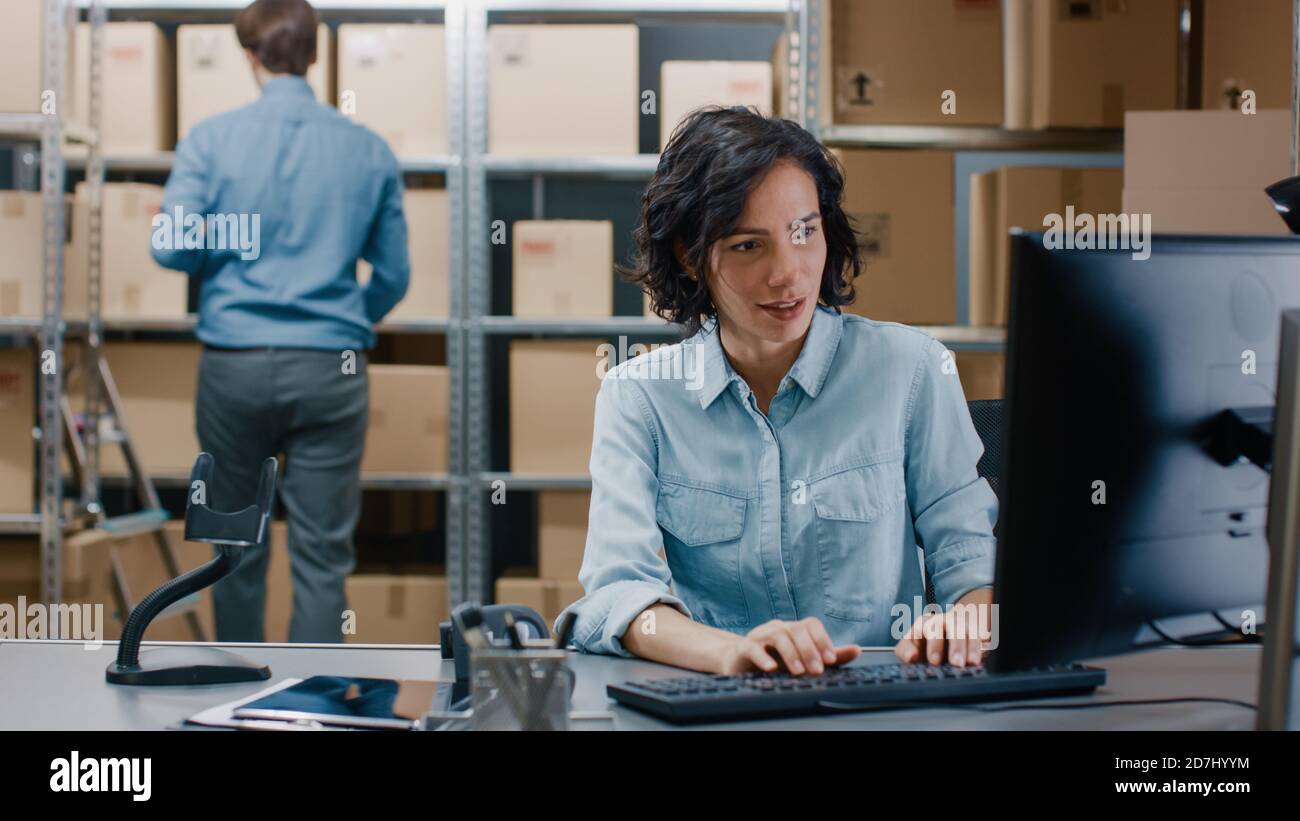 Female Inventory Manager Sitting at Her Desk and Using Personal ...