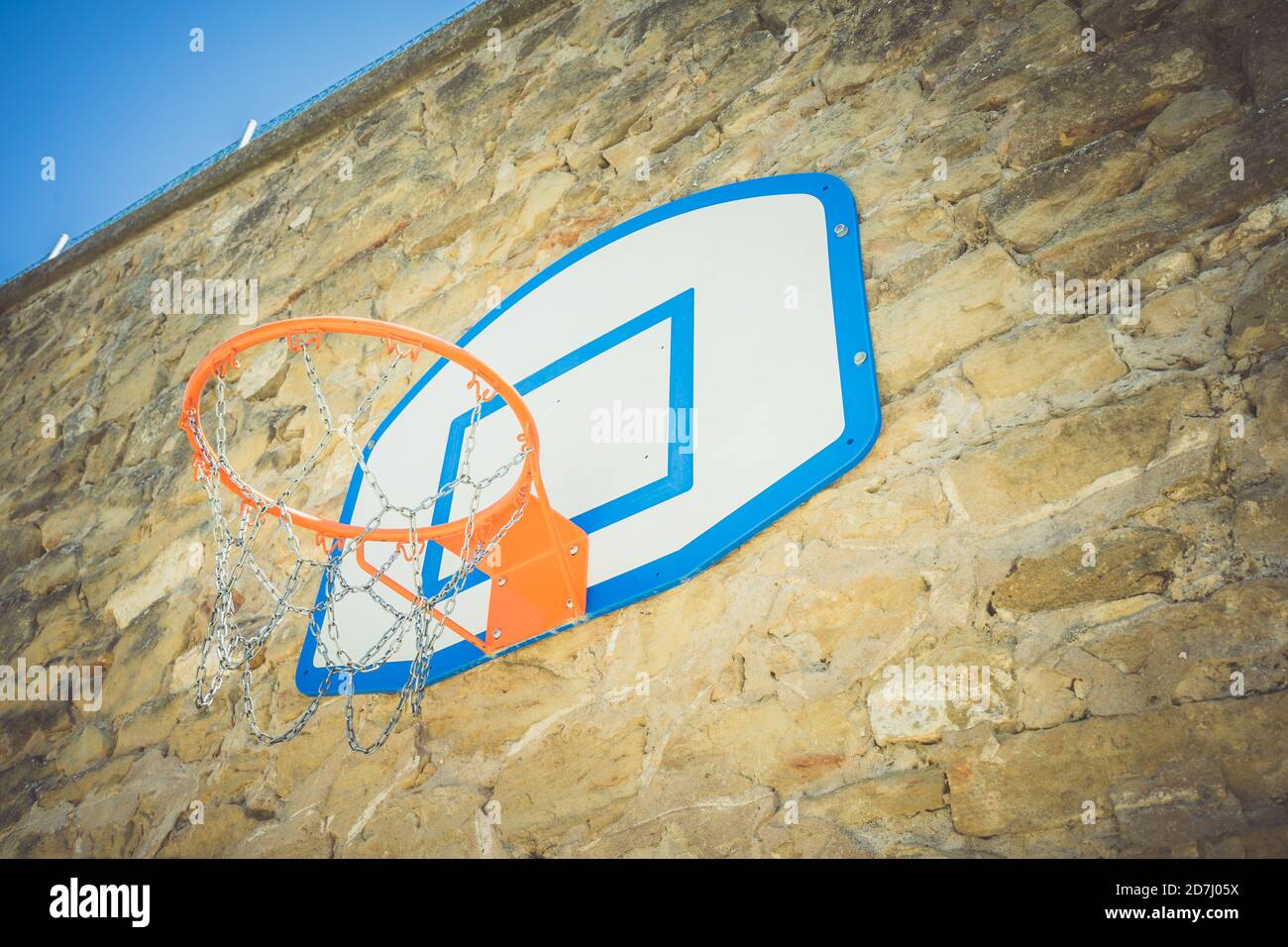 Low angle shot of basketball ring on stone wall Stock Photo - Alamy