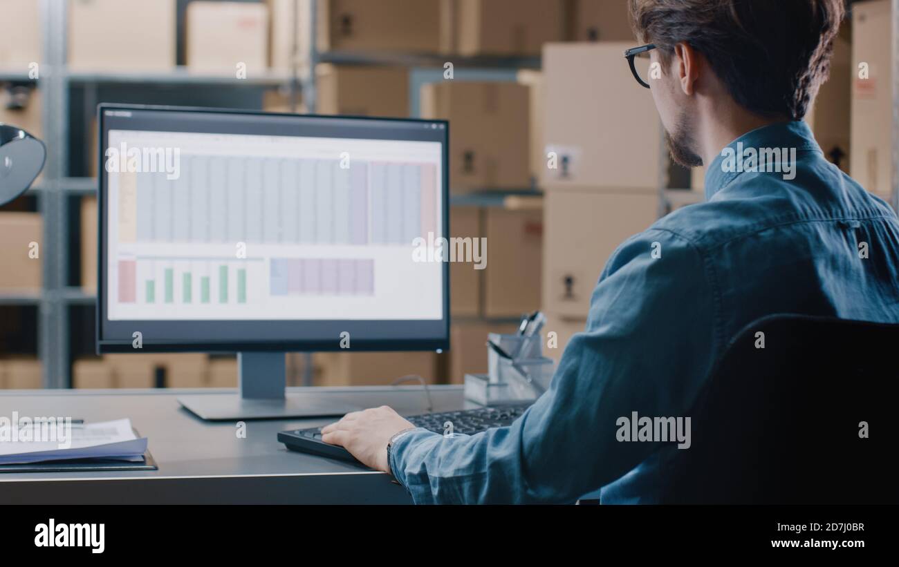 Man sitting on desk in warehouse hi-res stock photography and images ...