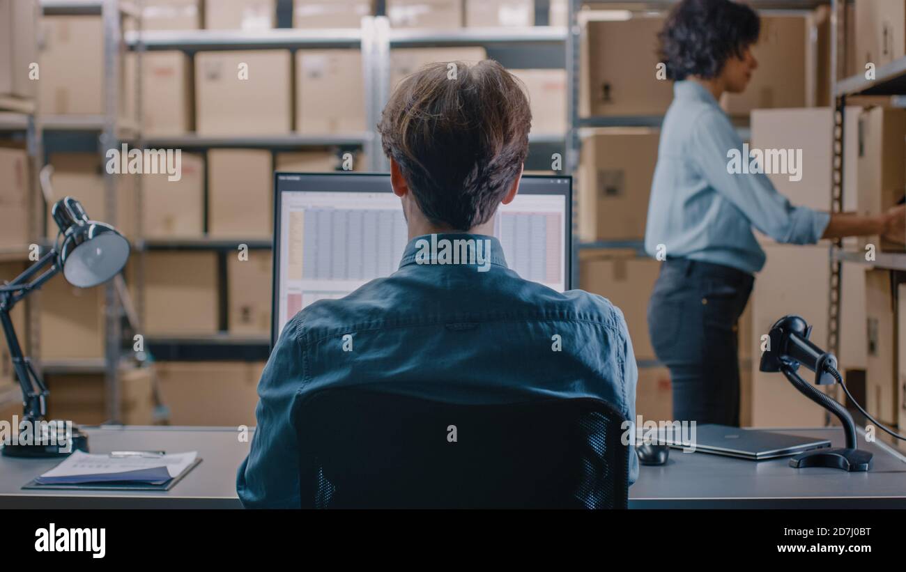 Warehouse Inventory Manager Talks to a Clerk Working with a Spreadsheet ...