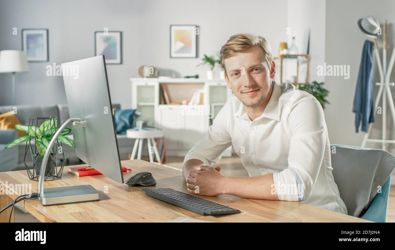 Portrait of the Handsome Young Man Looking at the Camera While Sitting ...