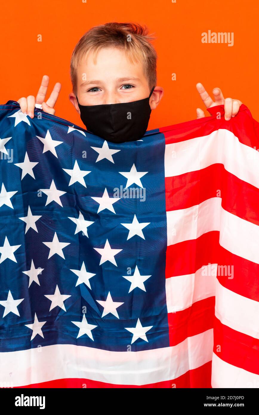 Attractive little boy with the flag of the United States, showing ...