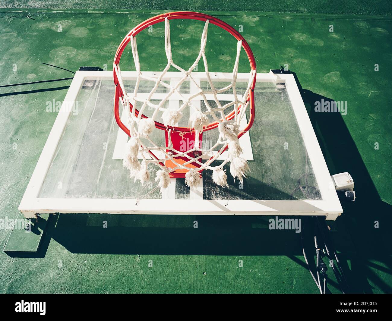 Front view of a basketball hoop on a green wall in the gymnasium Stock ...