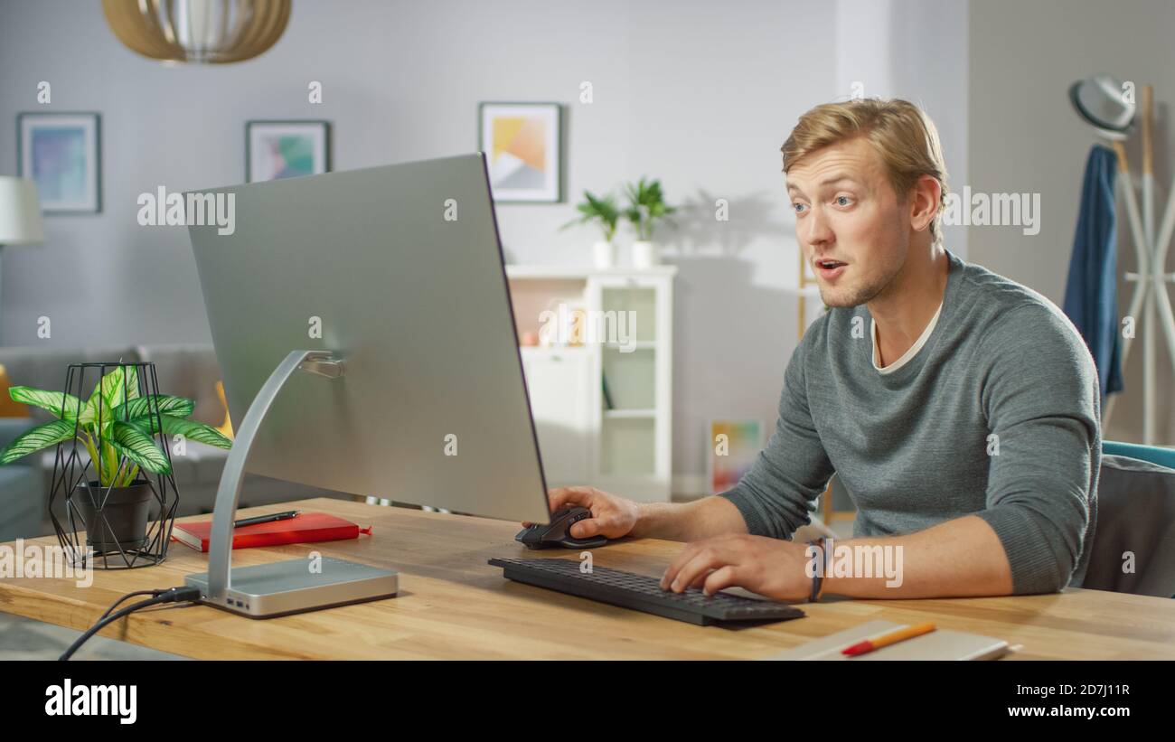 Portrait of Surprised Handsome Man Working on Personal Computer Has ...