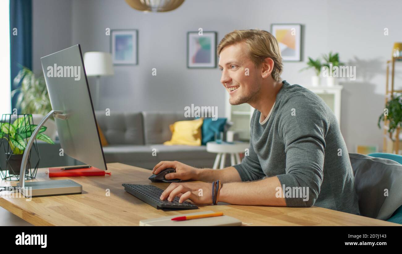 Portrait of the Handsome Smiling Man Working on Personal Computer while ...