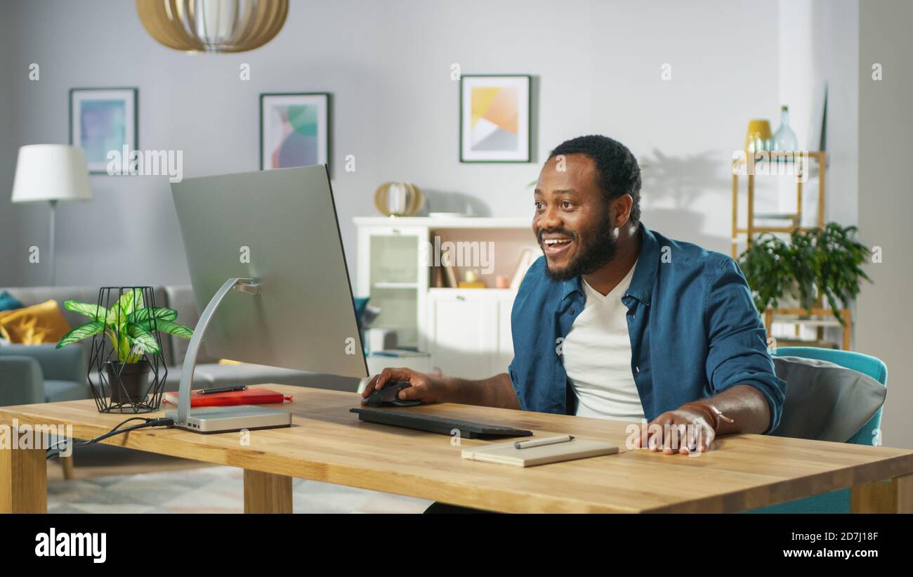 Shocked and Surprised Young Black Man Uses Personal Computer at Home ...