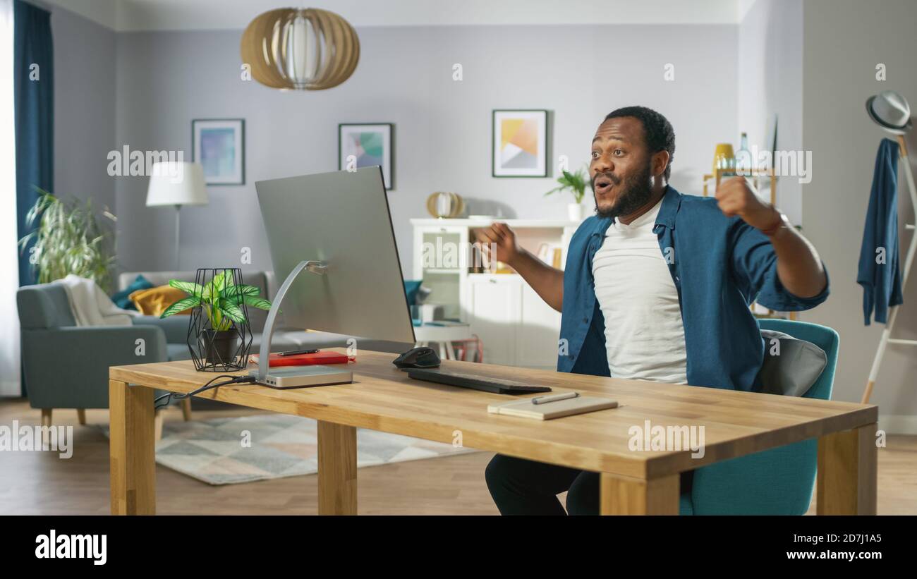 Happy Young Man Uses Personal Computer at Home, Wins Big, Does Air ...