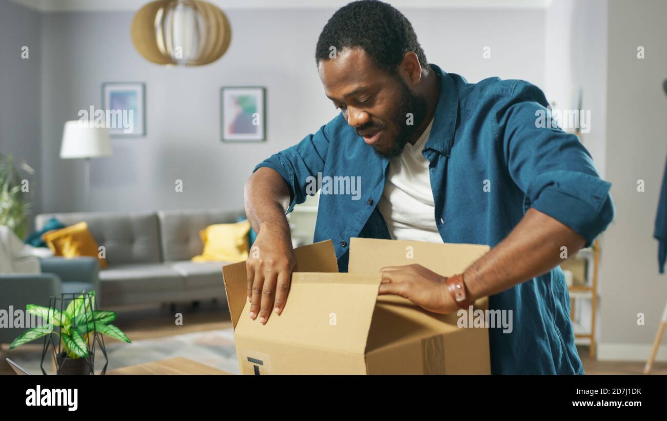 Handsome Excited Man Opens Cardboard Box Postal Package and Is Very ...