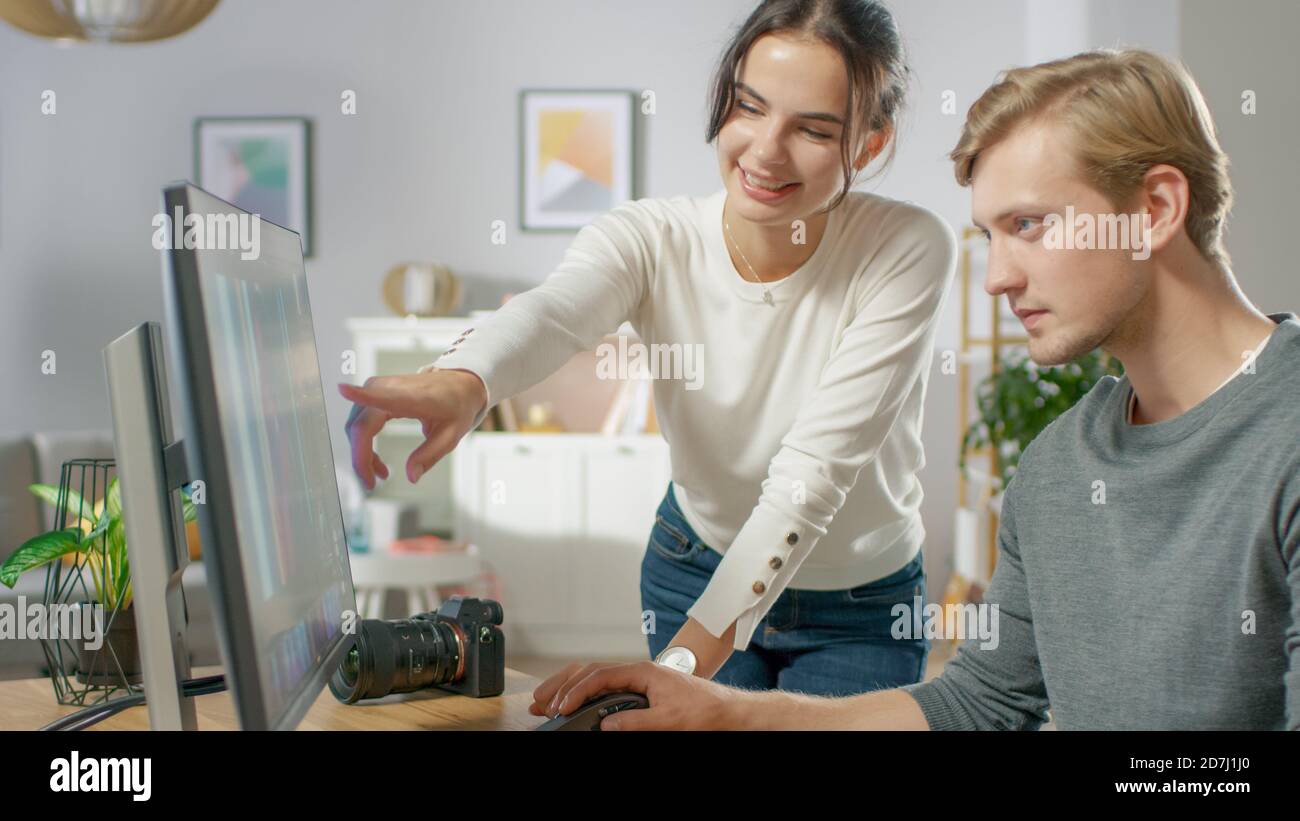 Male and Female Professional Editors Talk while Working in Photo ...