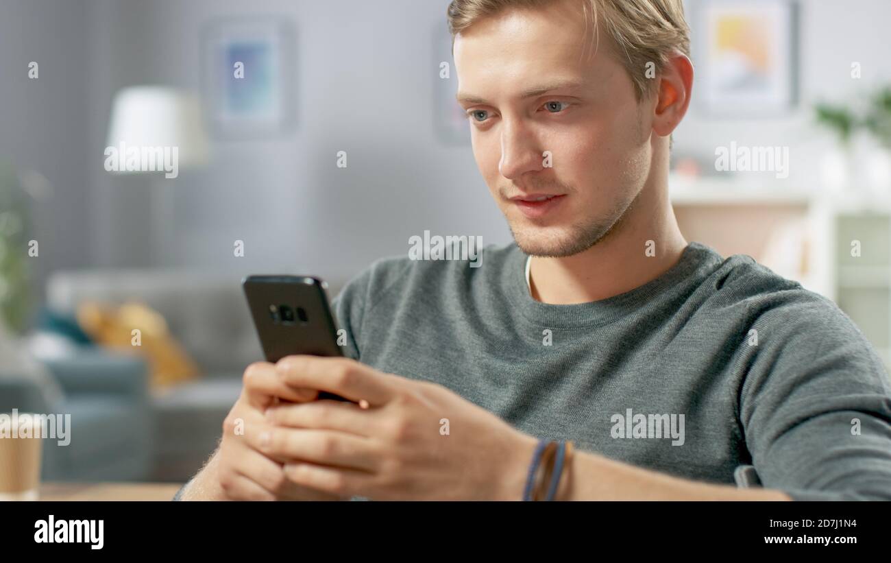Portrait of the Handsome Young Man Using Smartphone, Browsing in ...