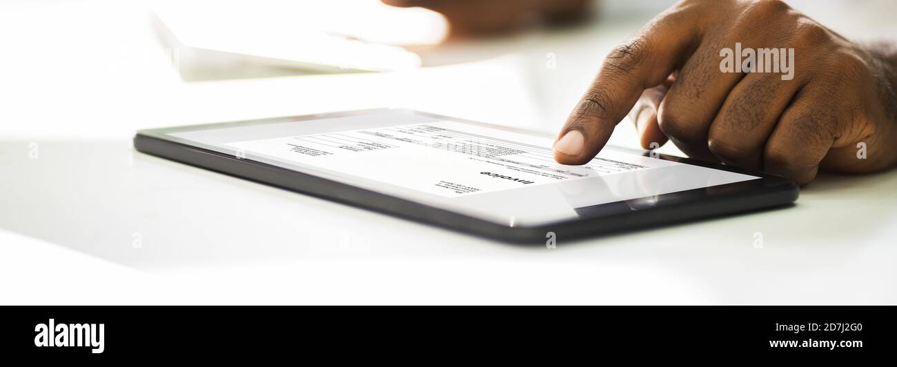 African Advisor Tax Audit Using Invoice Software Stock Photo - Alamy