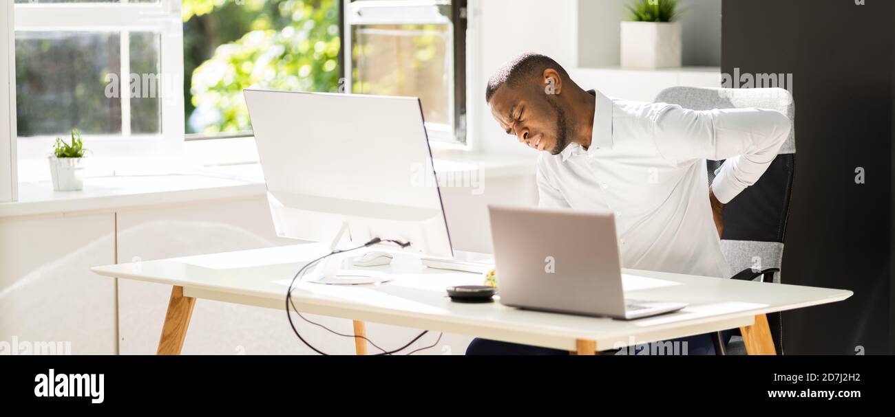 African American Man Back Pain At Work From Bad Posture Stock Photo - Alamy