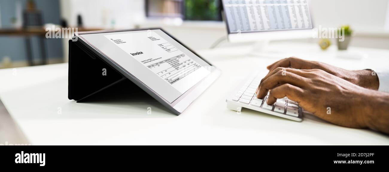 African Advisor Tax Audit Using Invoice Software Stock Photo - Alamy
