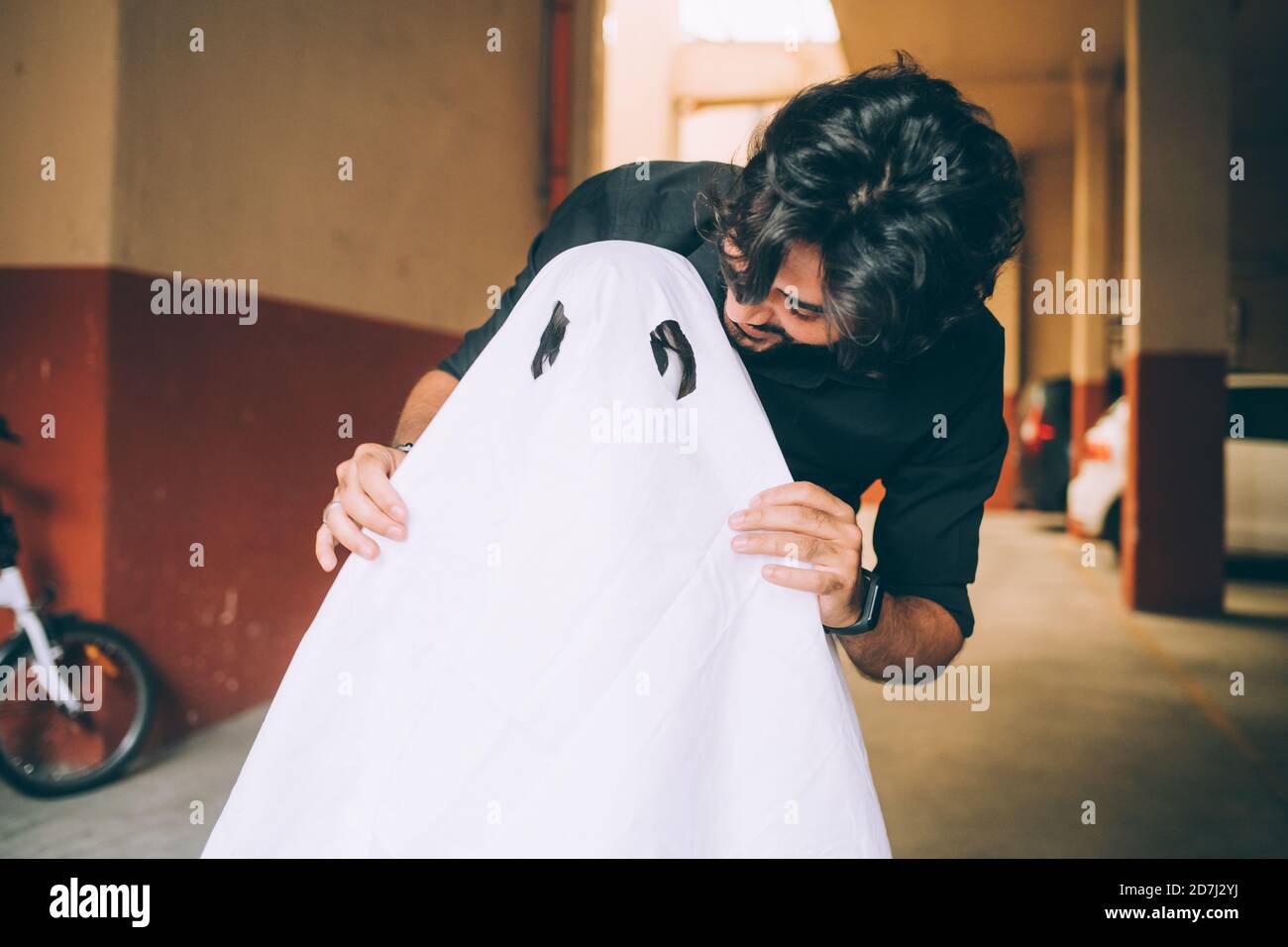 Father with child dressed as ghost Stock Photo - Alamy