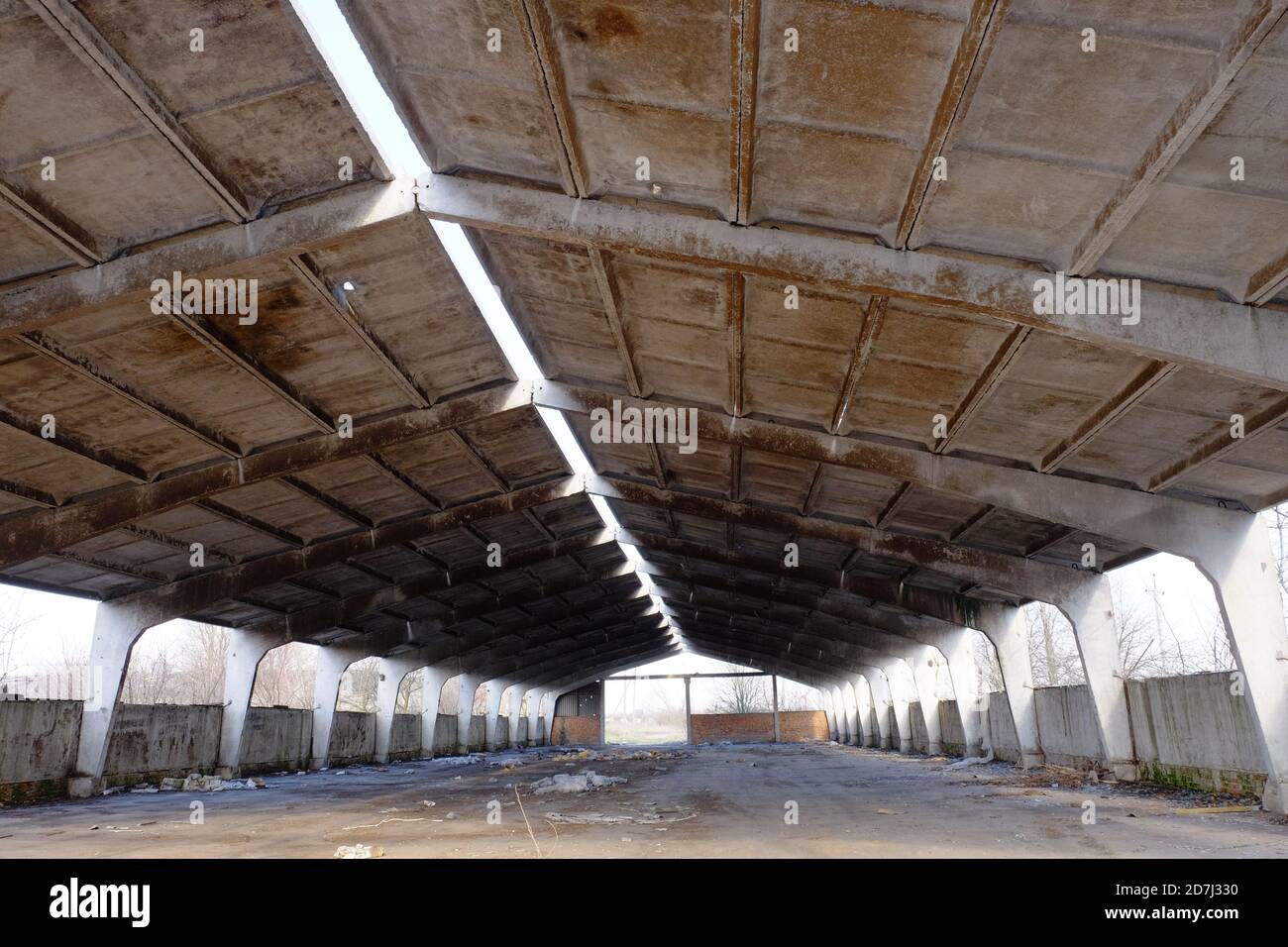 A dilapidated concrete industrial structure. Storage with concrete roof ...