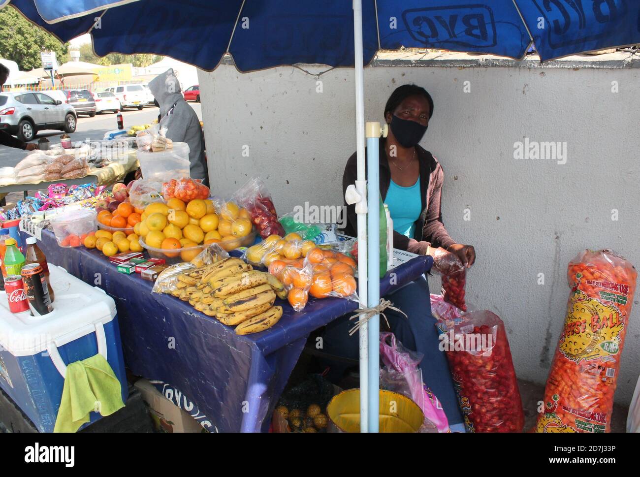 Windhoek, Namibia. 22nd Oct, 2020. A vendor wearing a face mask sells ...