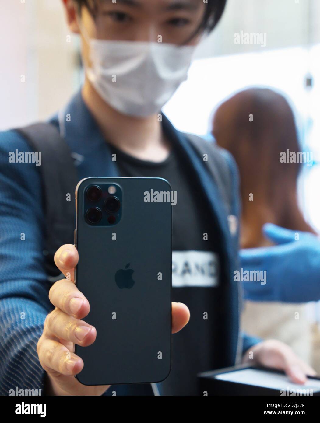Tokyo, Japan. 23rd Oct, 2020. A customer shows off his new iPhone 12 ...