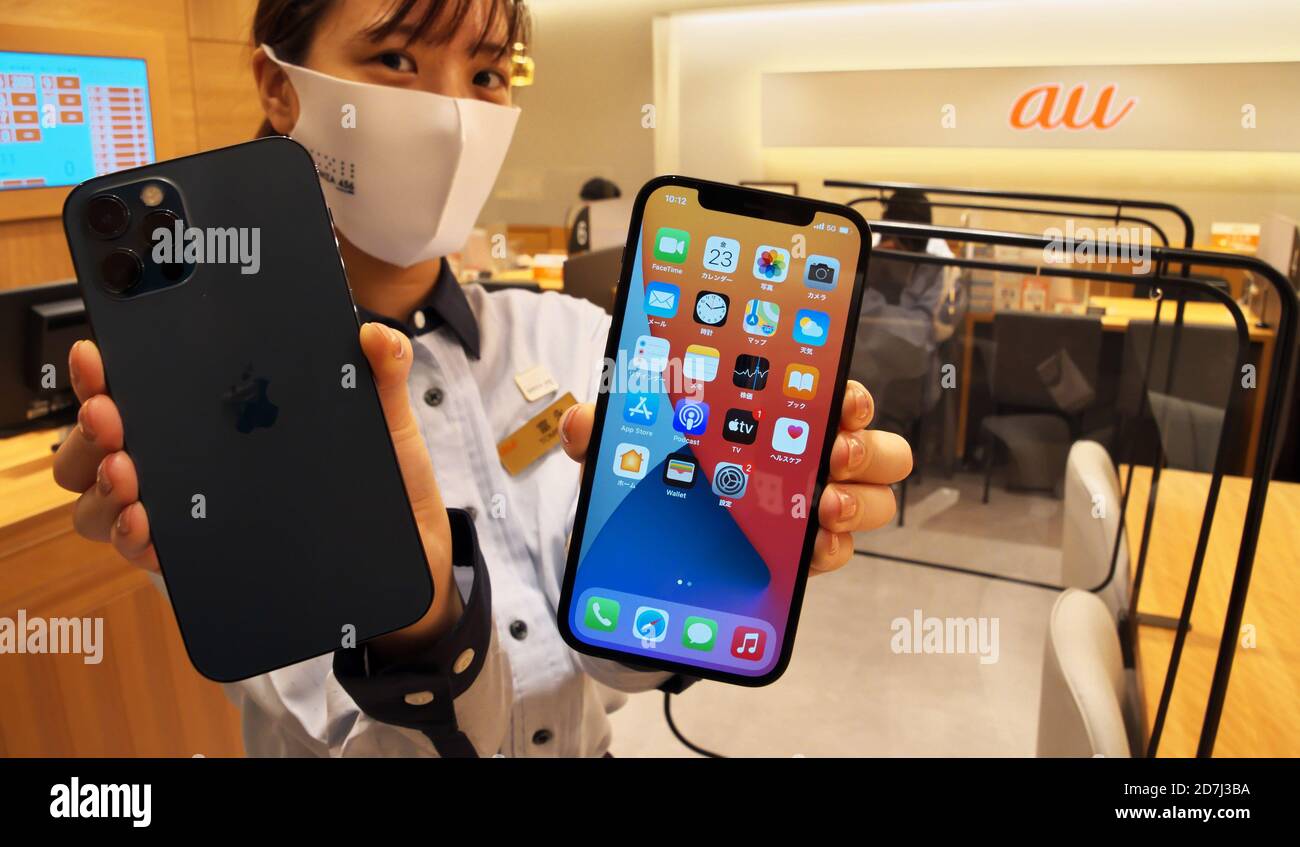 Tokyo, Japan. 23rd Oct, 2020. A employees poses with new iPhone 12 Pro ...