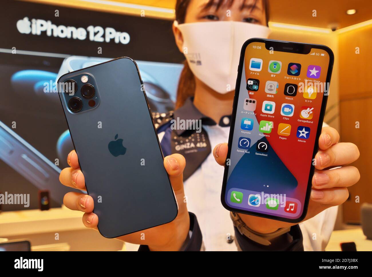 Tokyo, Japan. 23rd Oct, 2020. A employees poses with new iPhone 12 Pro ...