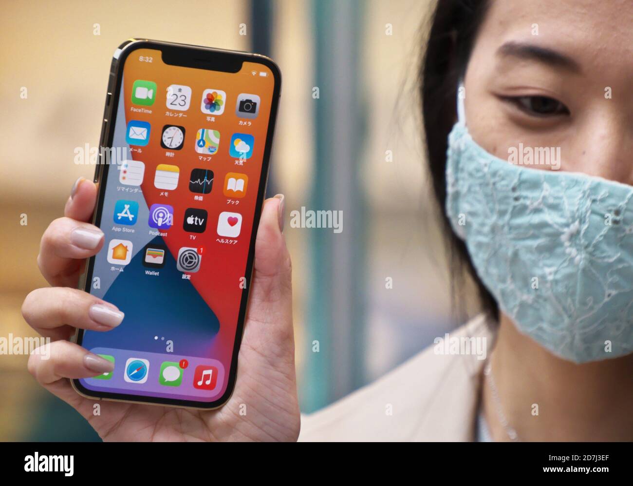 Tokyo, Japan. 23rd Oct, 2020. A customer shows off her new iPhone 12 ...