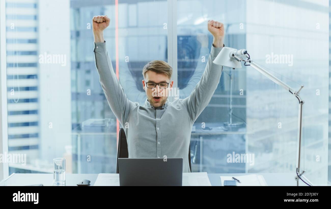 Man celebrates success desk hi-res stock photography and images - Alamy