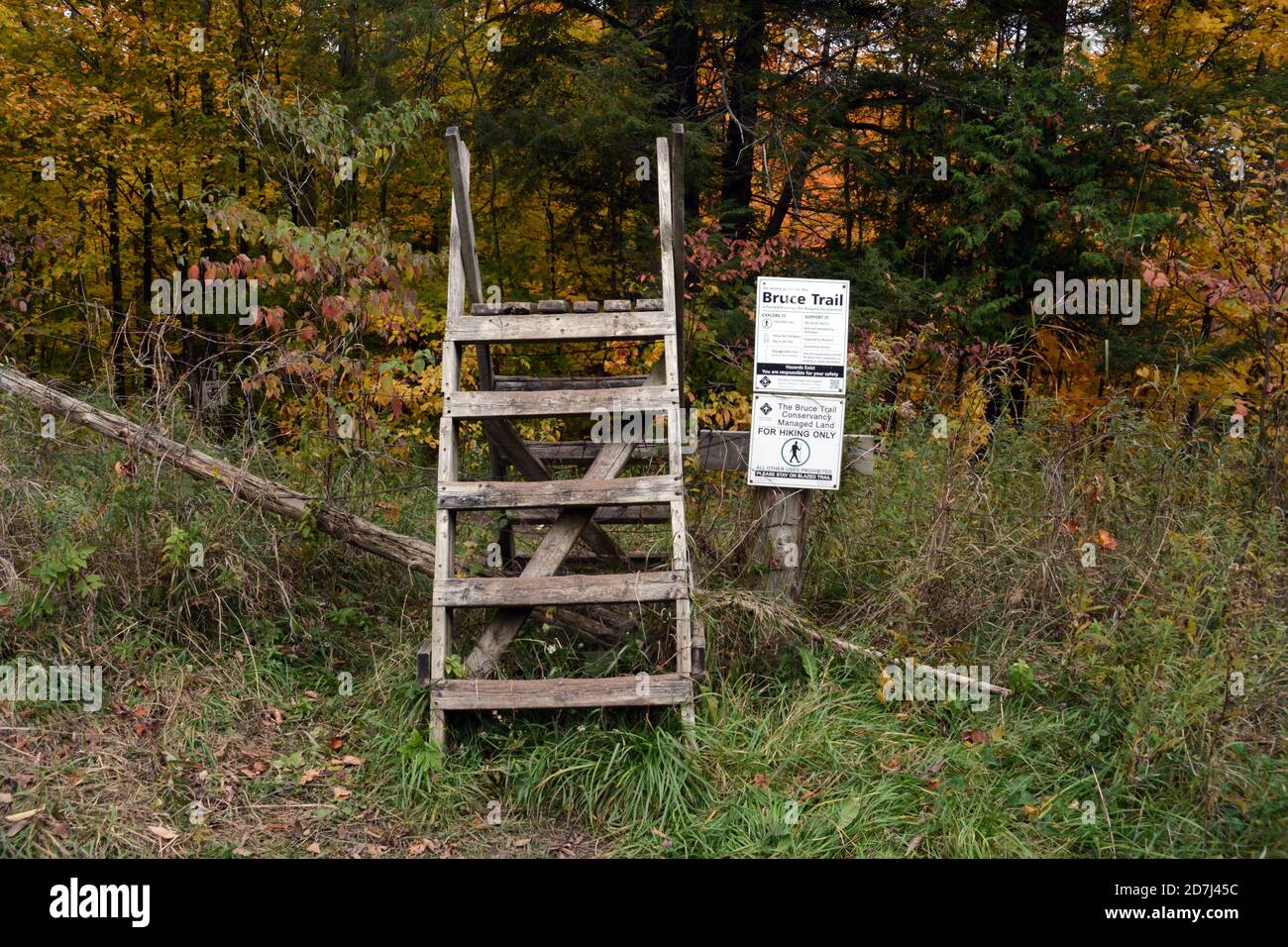 A fence stile and sign at a trailhead and access point to the Bruce ...