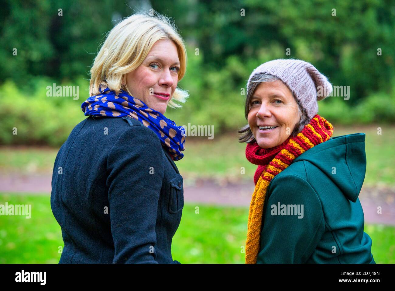 portrait of two women in their 50s standing in park in autumn Stock ...