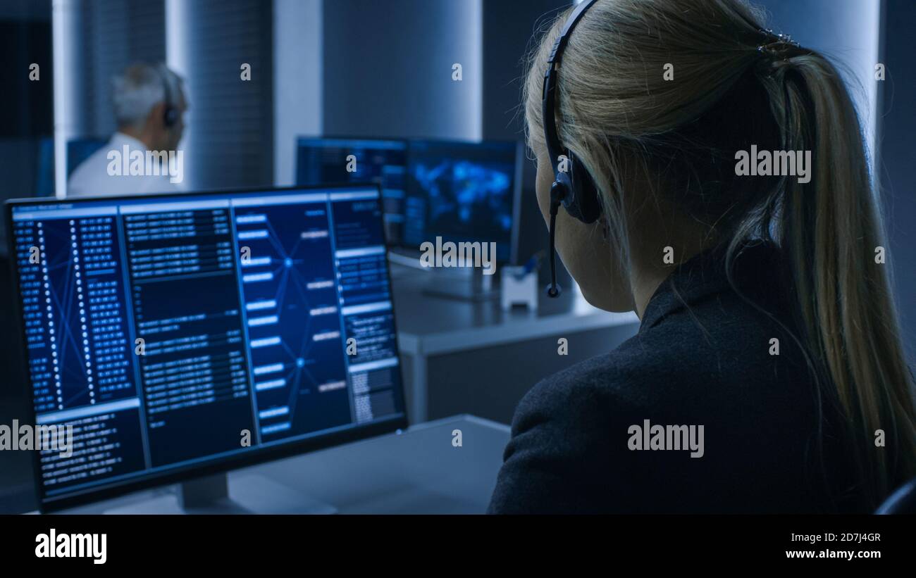 Back View of the Female Controller wearing Headset Working on Personal ...