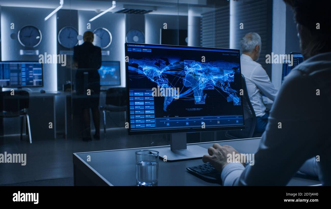 Back View of the Cyber Security Officer Working on Personal Computer ...