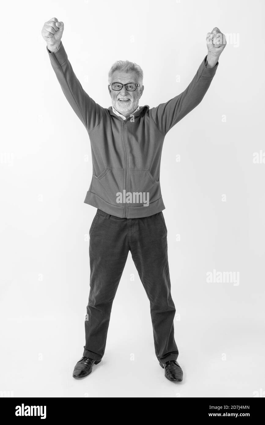 Full body shot of happy senior bearded man smiling while standing and ...
