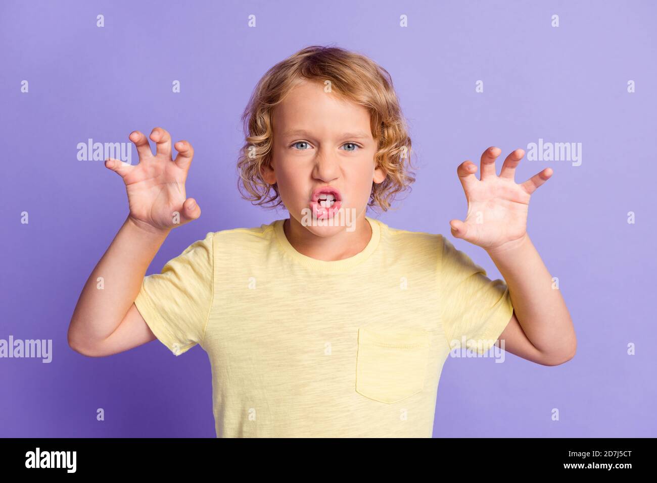 Photo of frightening small boy look in camera raise hands claws ...