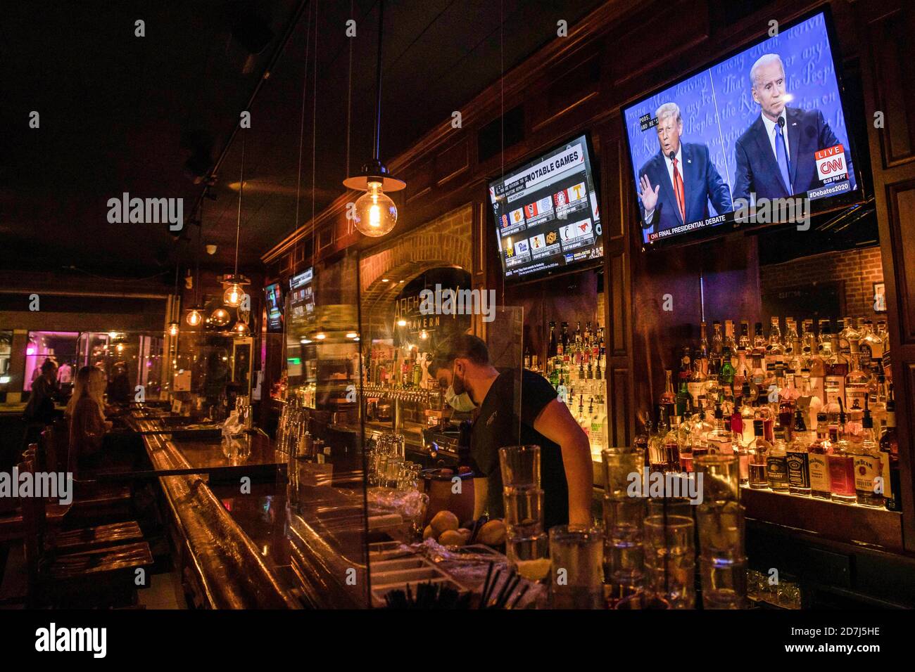 Donald Trump and Joe Biden seen speaking on a Tv screen at Oddfellows ...