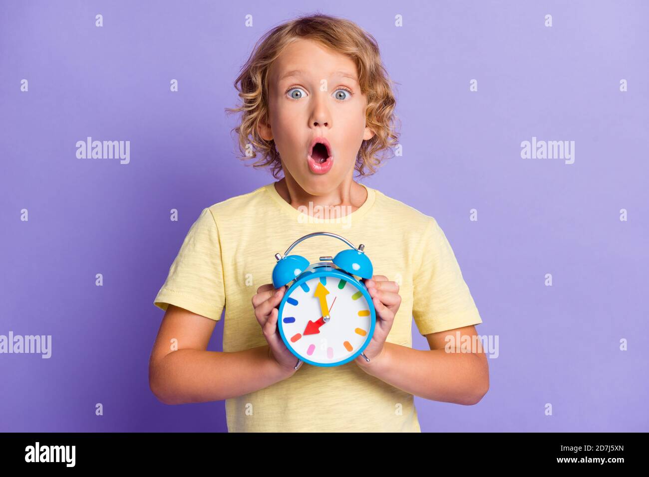 Photo of astonished small boy feel frustrated hold clock missed late ...