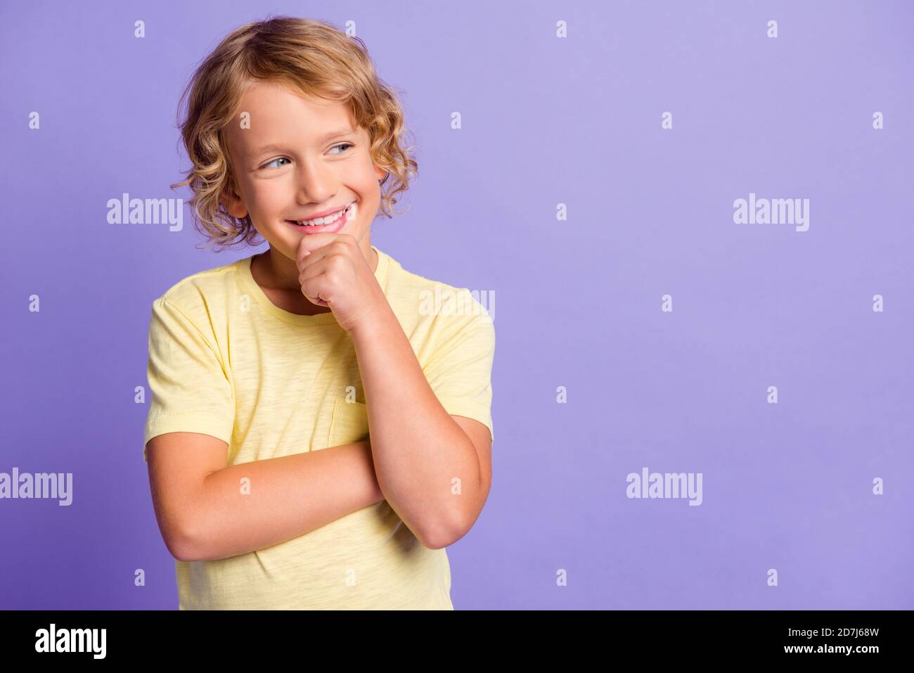 Photo of minded kid touch fingers face look empty space think thoughts ...