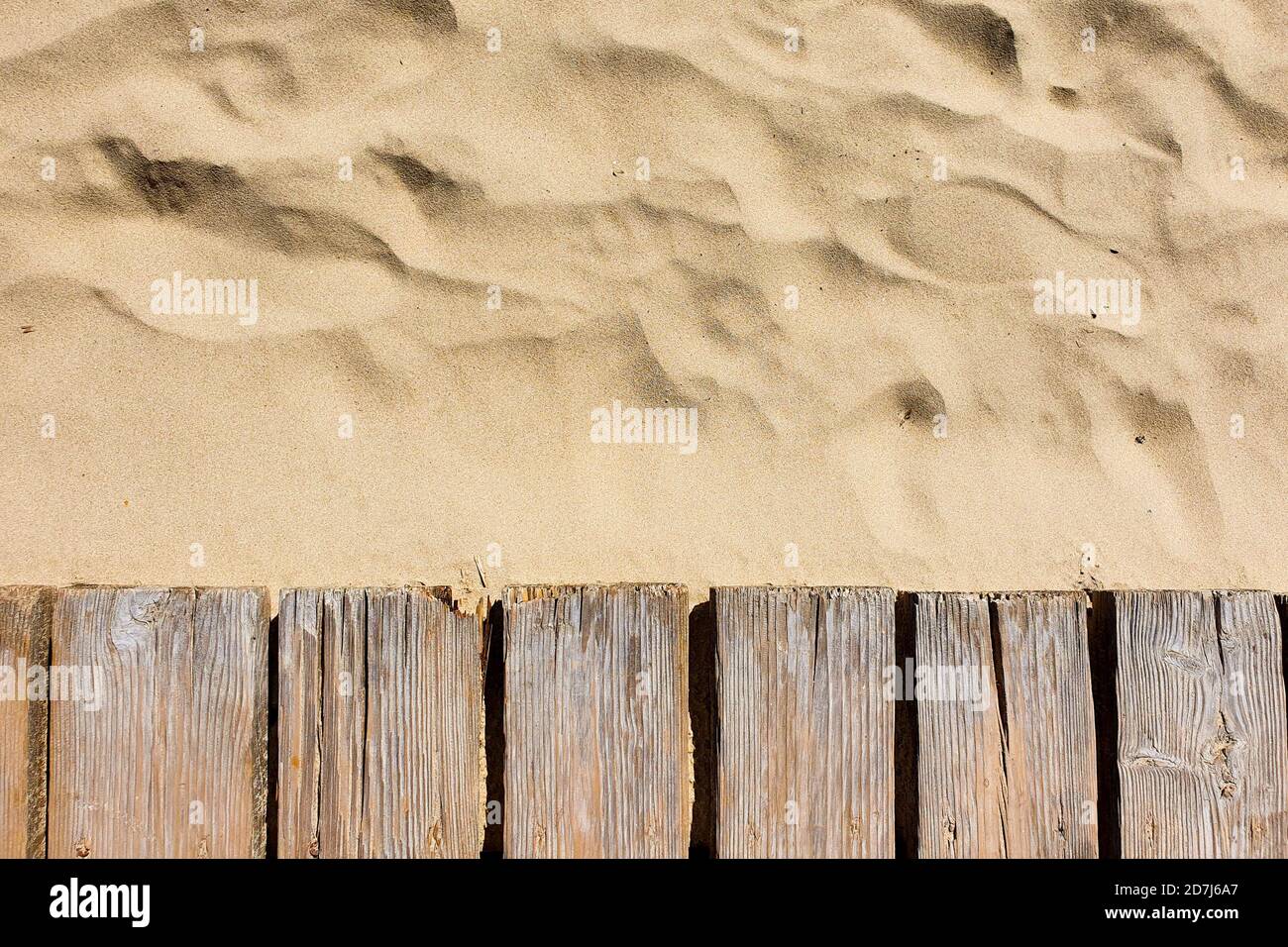 Wooden walkway on the sandy beach. Wooden boardwalk and light soft sand ...