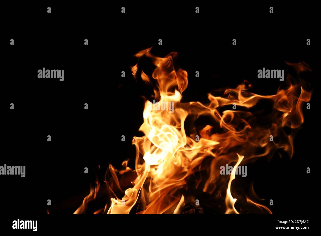 Tongues of flame of fire of orange-yellow color from burning firewood ...