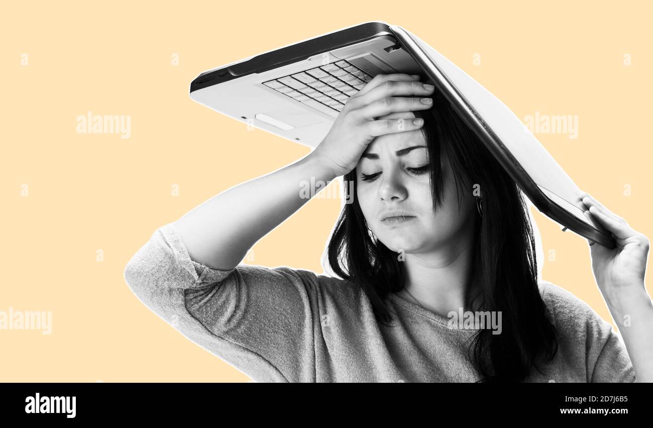 Problems with computer. Young stressed woman with laptop on the head ...