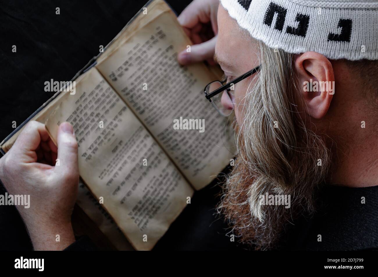 Hasidic Jew reads Siddur. Religious orthodox Jew with red beard and ...