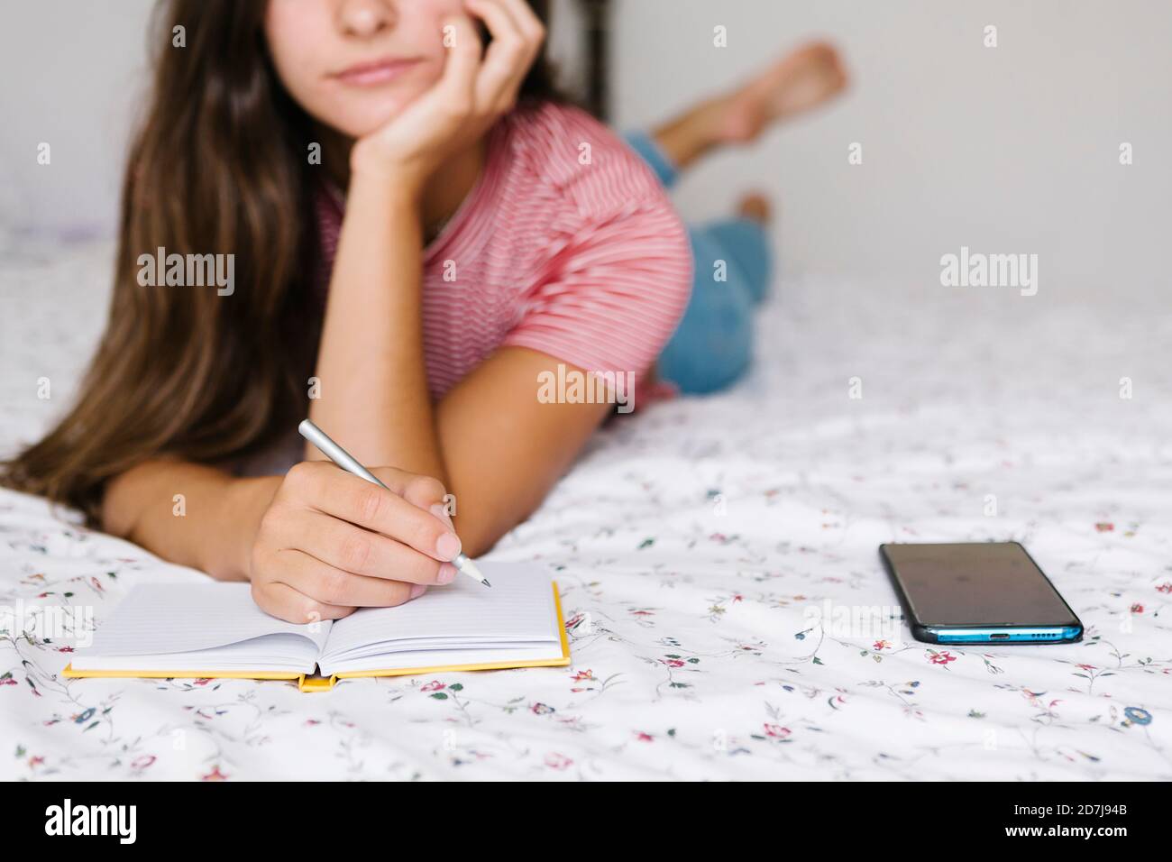 Woman lying on bed writing hi-res stock photography and images - Alamy