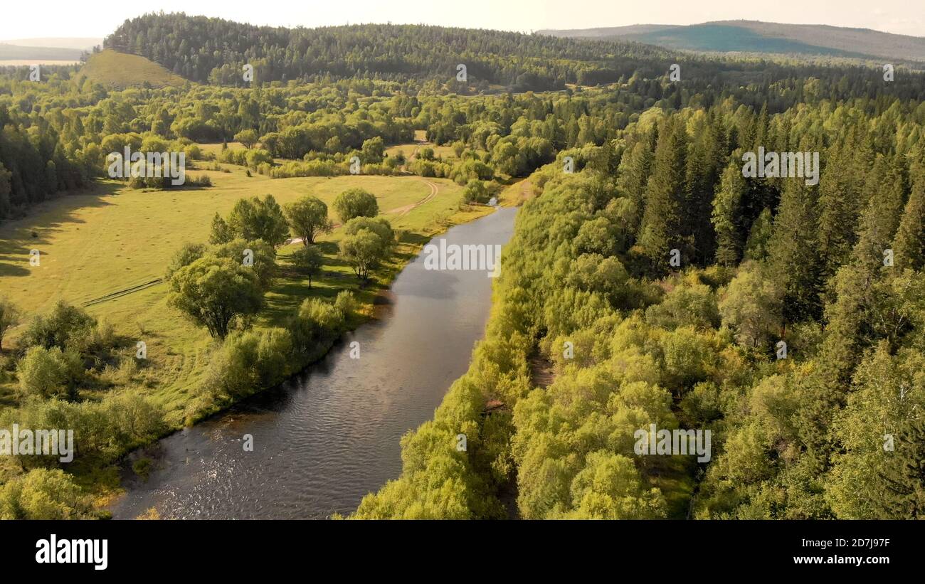 Aerial view from drone over mountain river, field, forest and path ...