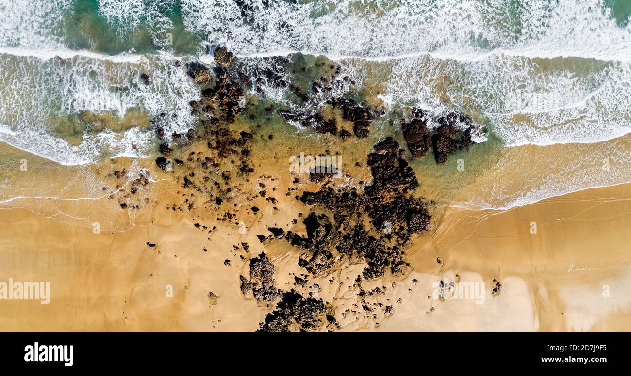 Aerial view of rocks on sandy coastal beach Stock Photo - Alamy