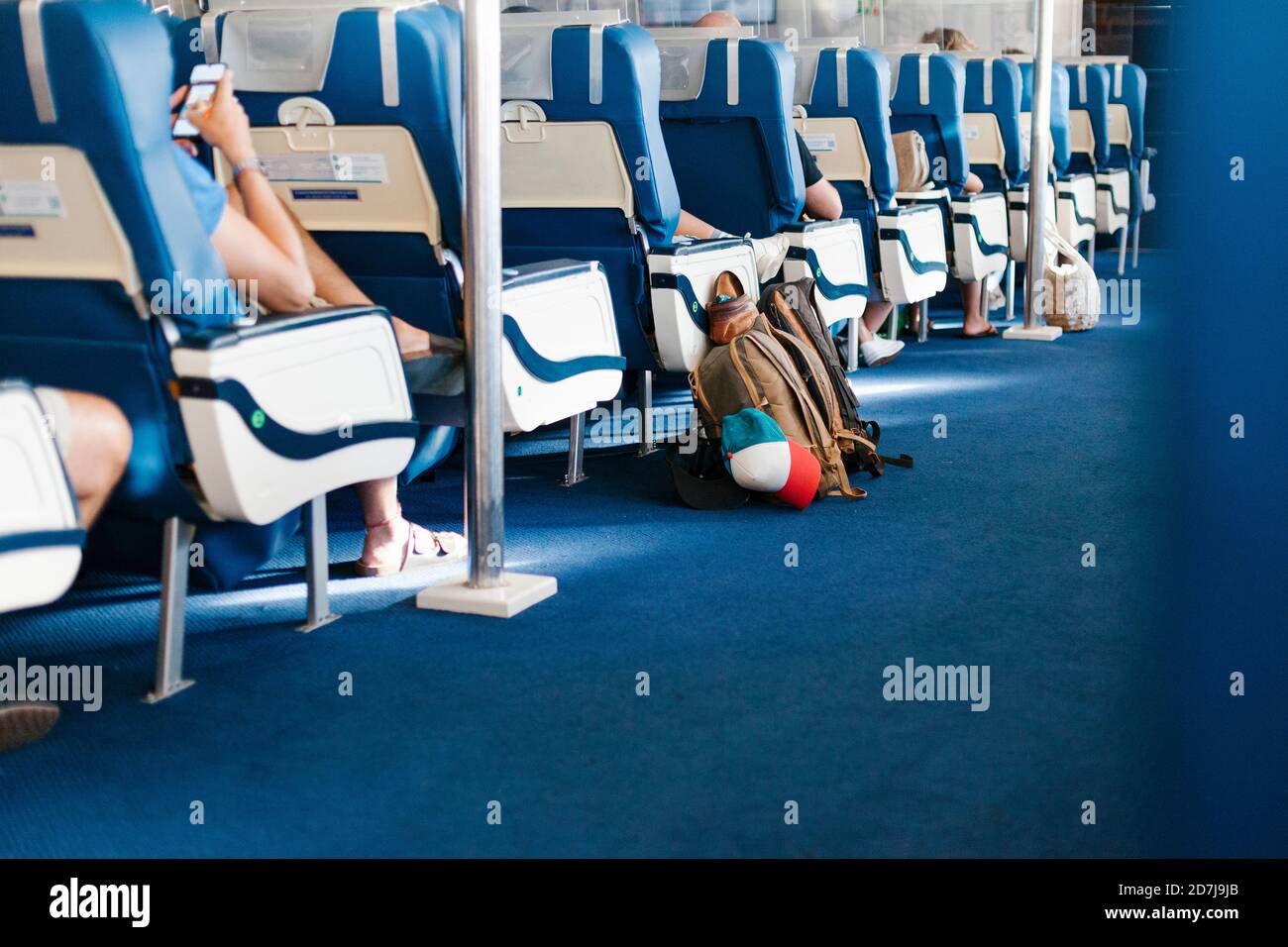 Passengers sitting on seats in cruise ship Stock Photo - Alamy