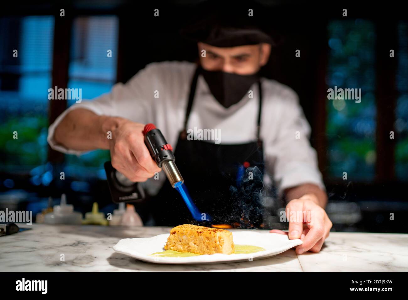 Chef preparing pudding while giving flame in restaurant kitchen Stock ...