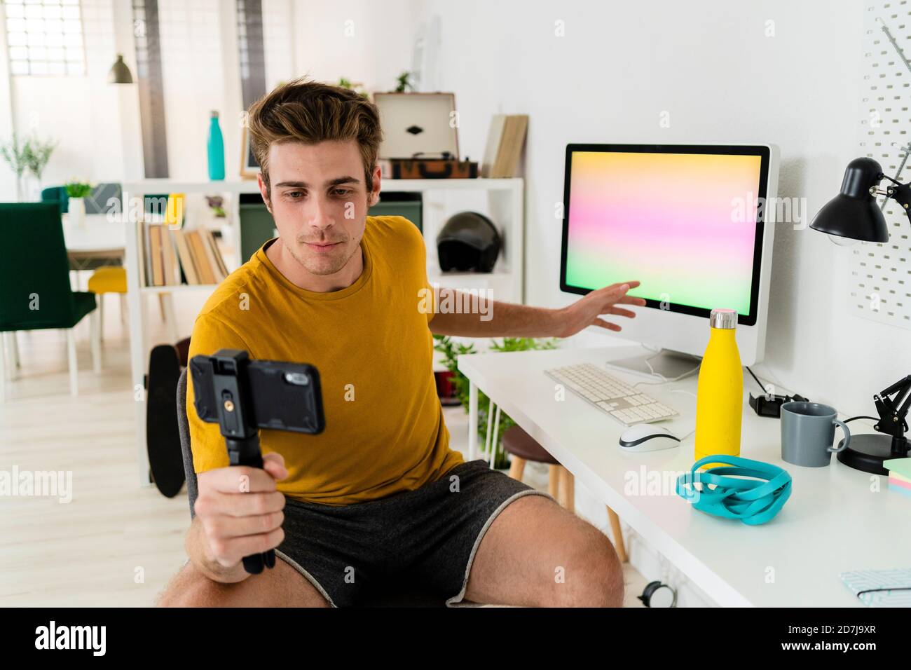 Fitness trainer showing computer during live streaming at home Stock ...