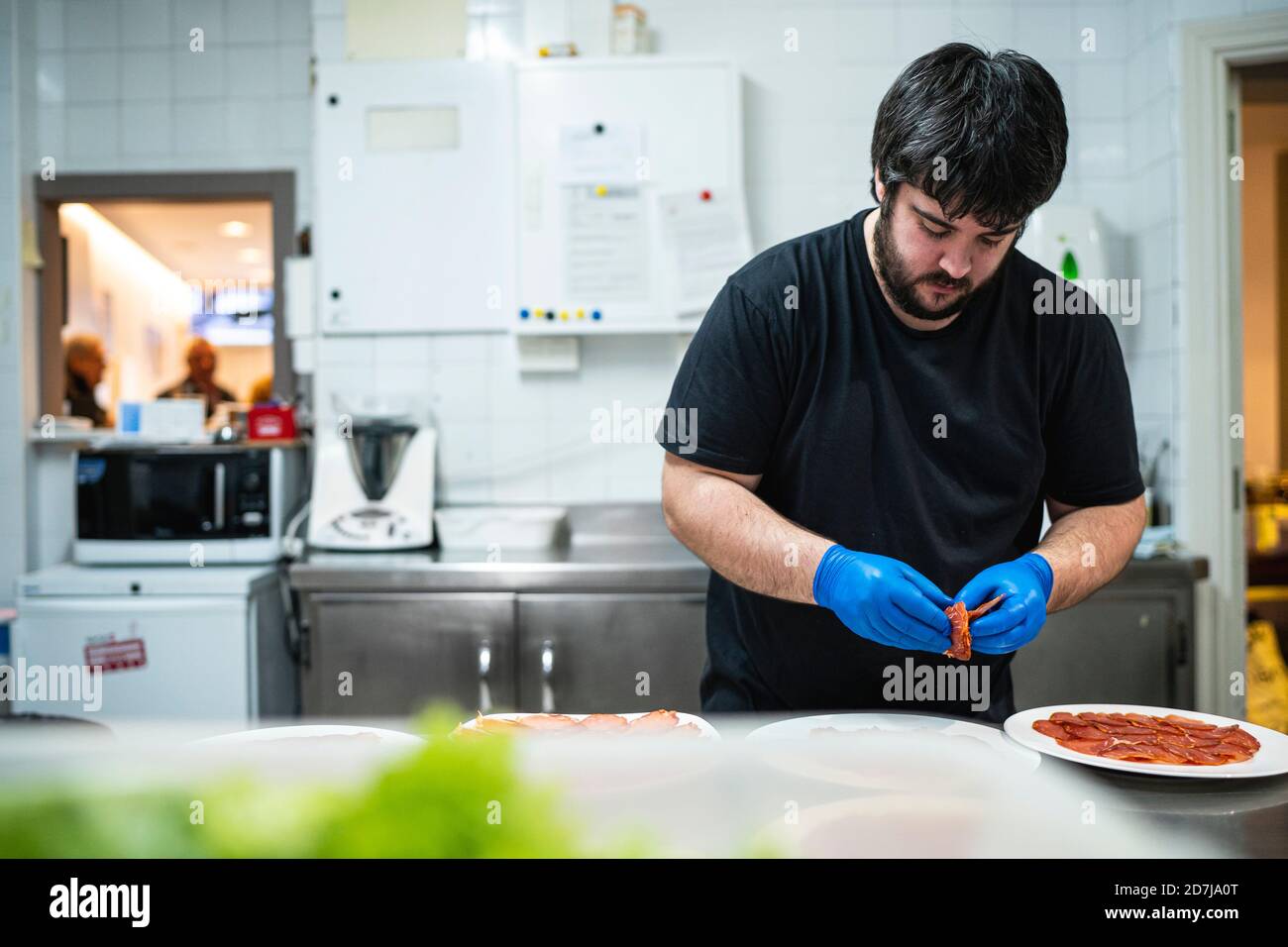 Chef working while standing at commercial kitchen Stock Photo - Alamy