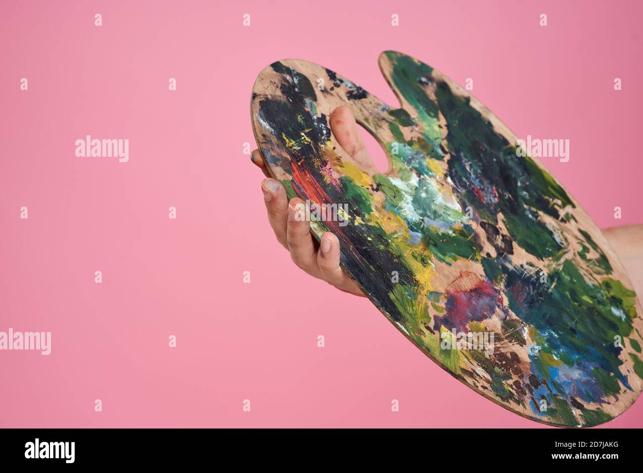 Palette with paints in hand artist drawing pink background occupation ...