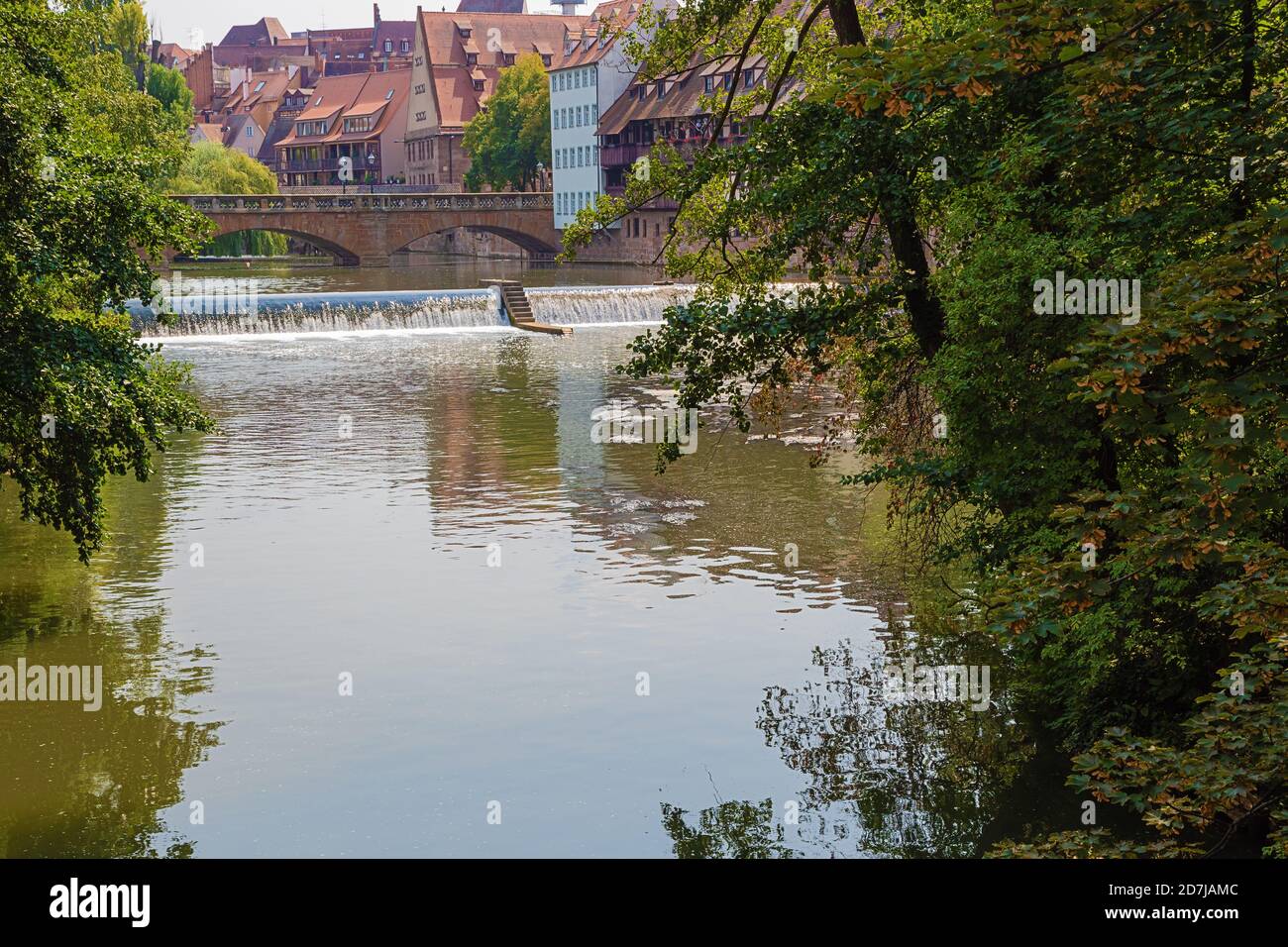 The Pegnitz river entering the old town near the Haller Gate Bridge ...
