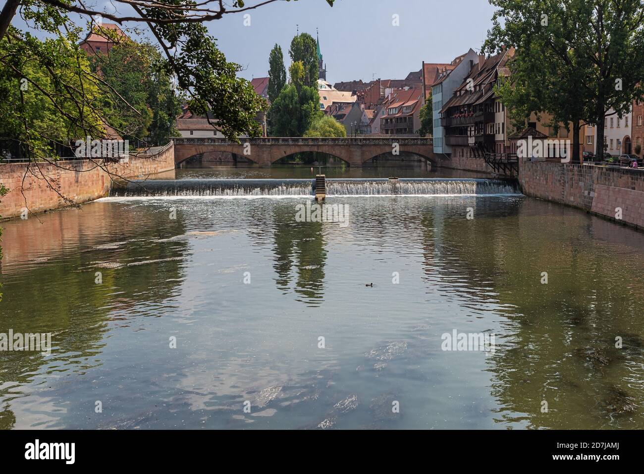 Walking over the Pegnitz River in Nuremberg near the Haller Gate Bridge ...